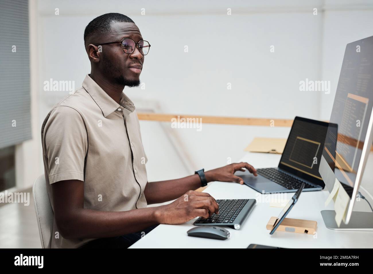 Portrait of programmer working on computer, testing code of new ...