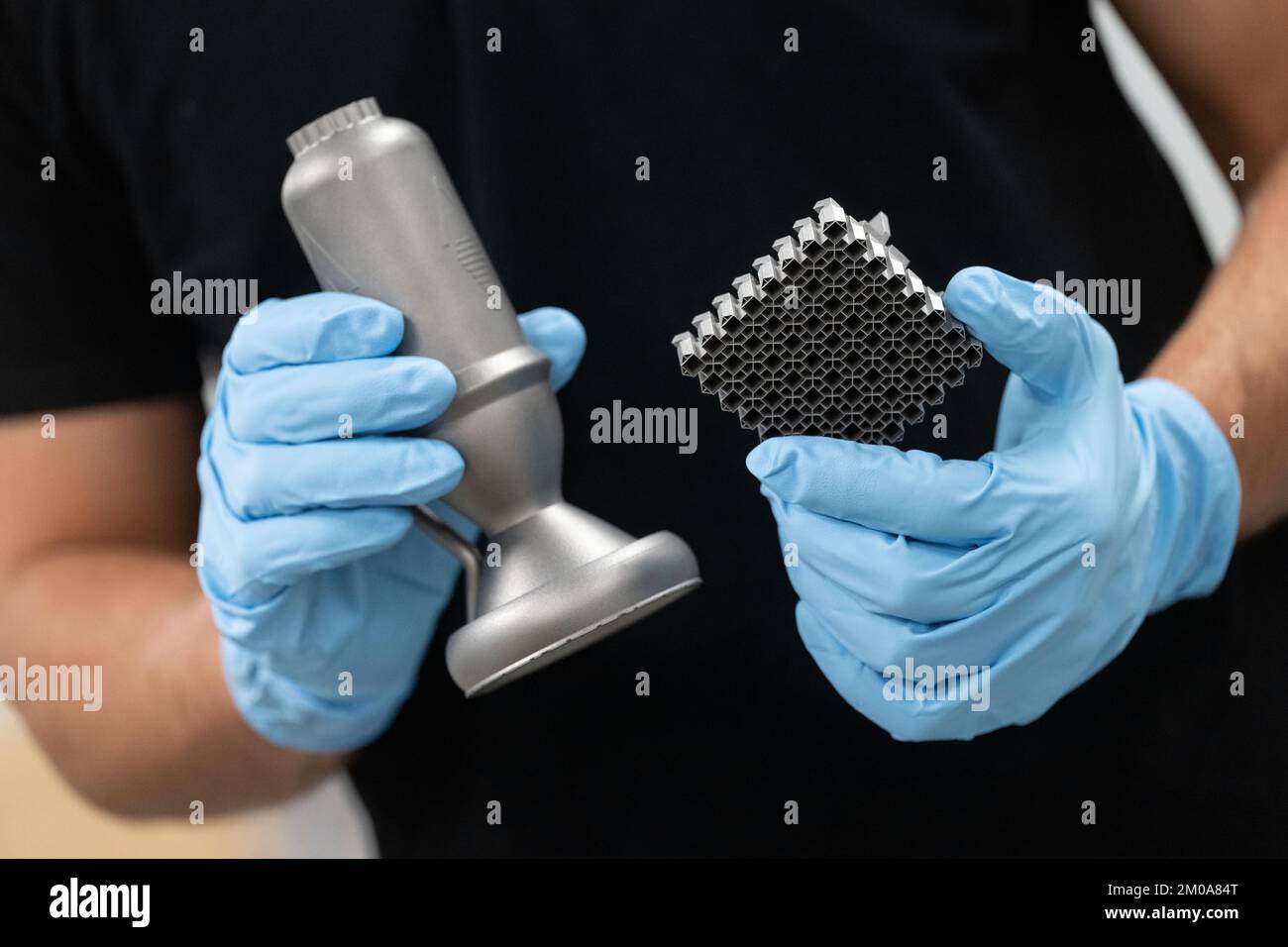 Ditzingen, Germany. 30th Nov, 2022. An employee of laser specialist Trumpf shows the cutaway ...