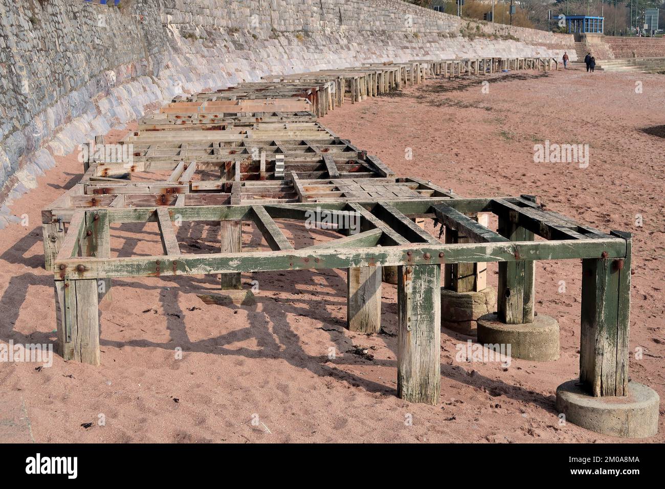 Wooden supports along the seawall on Corbyn's beach, Torquay, used as a ...