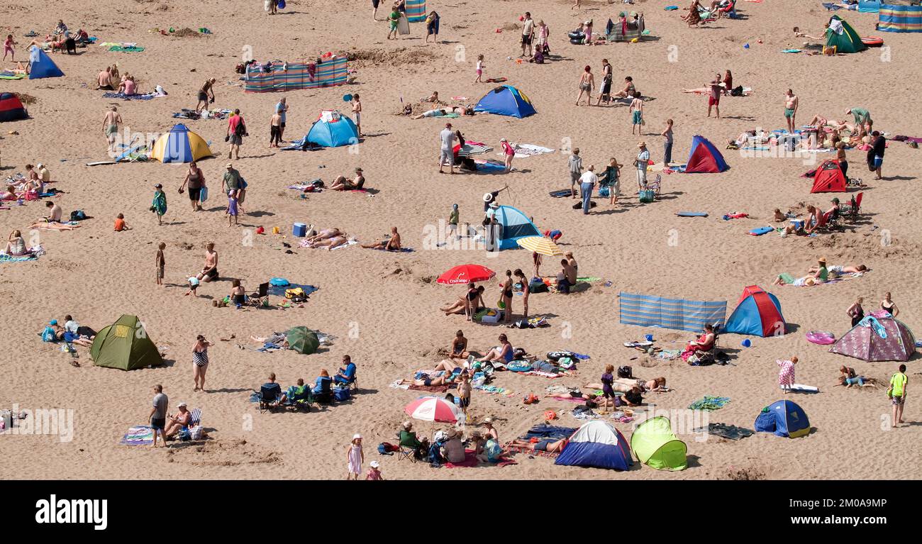 Crowded Beach with holidaymakers in summer at Mwnt Cardigan Ceredigion ...