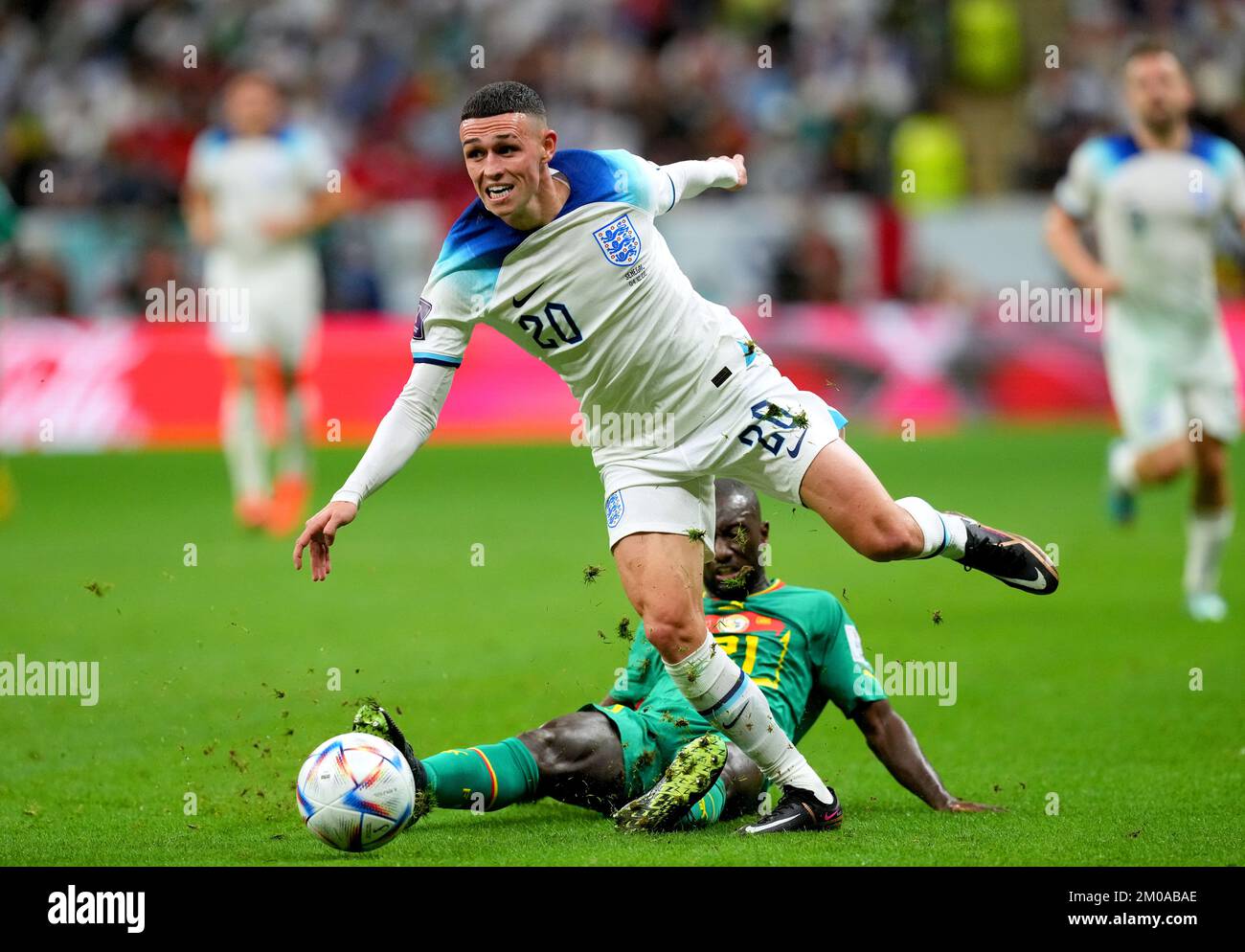 England's Phil Foden evades being tackled by Senegal's Youssouf Sabaly ...