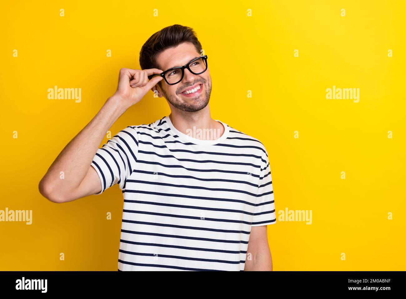 Photo of cheerful nice man toothy smile hand touch glasses look empty ...