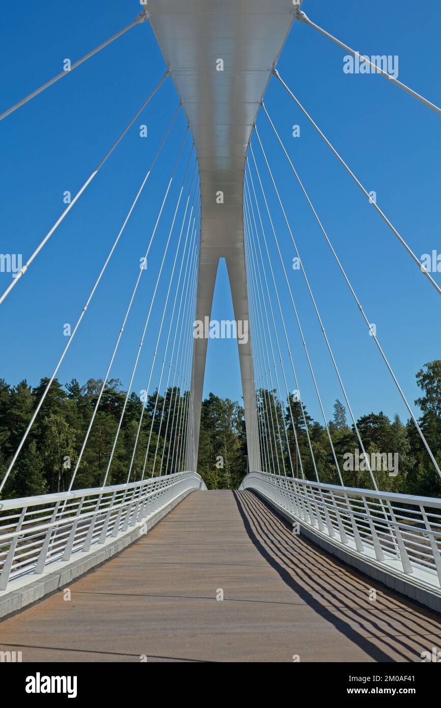 White modern steel cable bridge against blue sky Stock Photo - Alamy