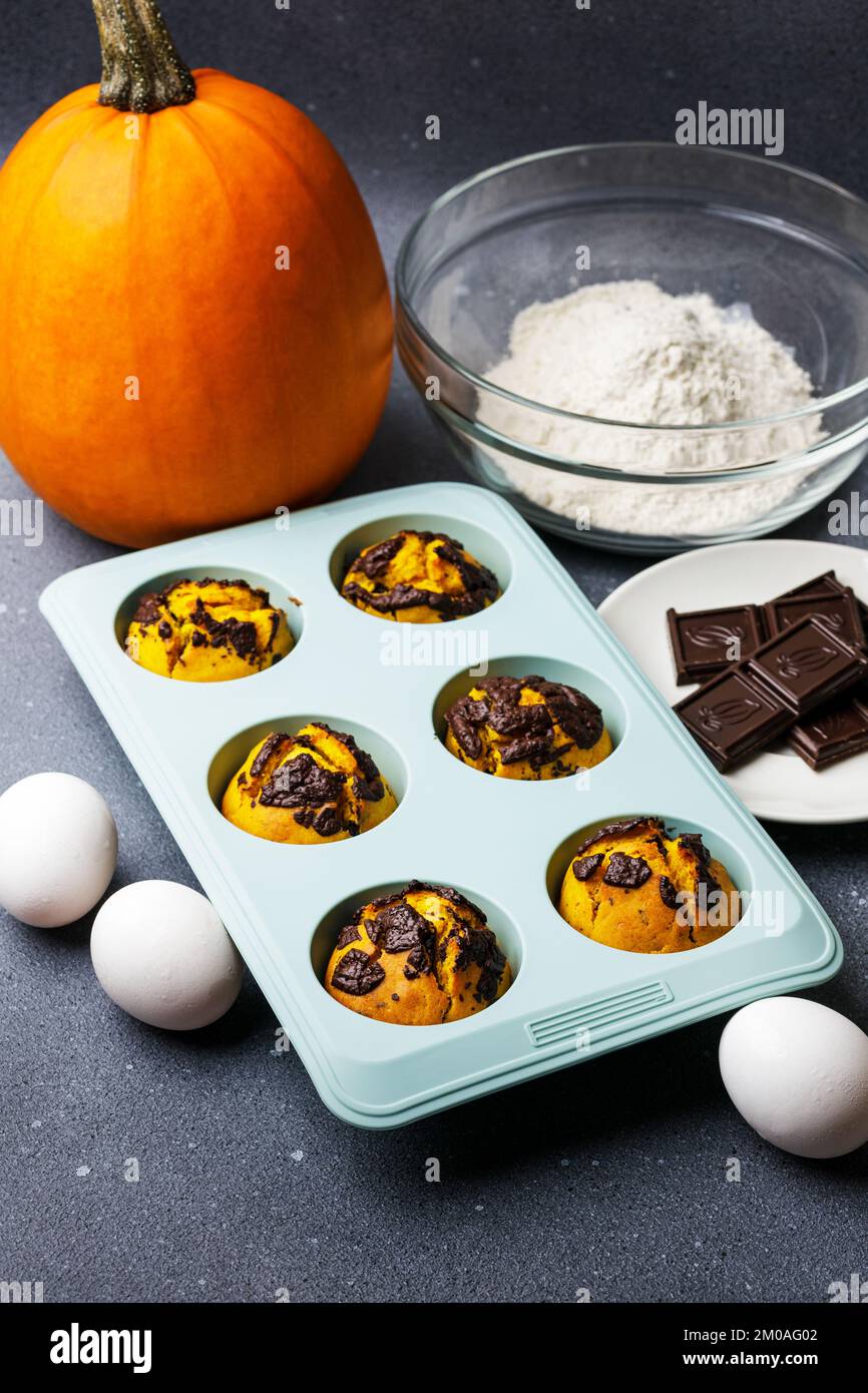 Pumpkin muffins baked in the silicone mold at the table with ...