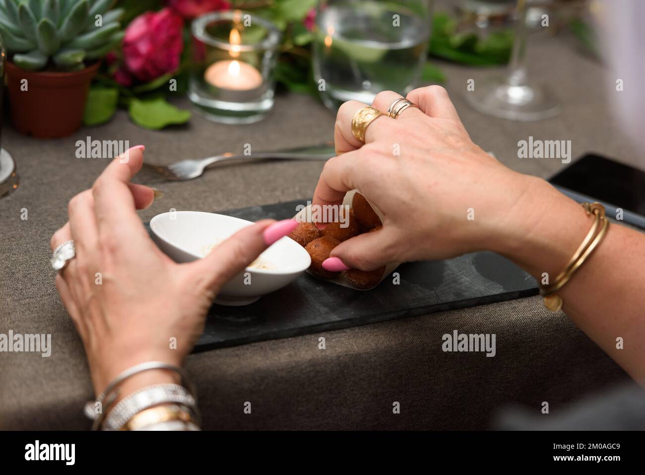 Beautiful breakfast. Women eating Croatian donuts with potatoes and ...