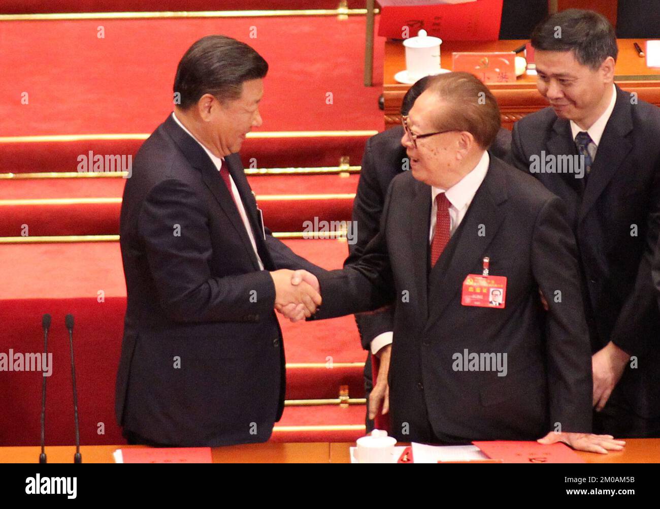 (front L to R) Xi Jinping and Jiang Zemin shake hands. The 19th ...