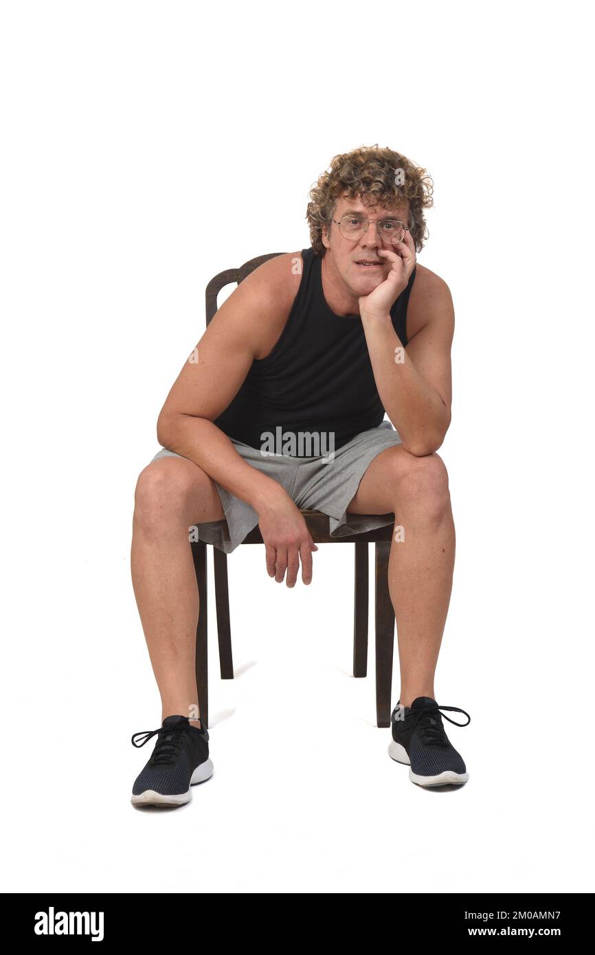 front view of a man sitting on chair with hand on face on white ...