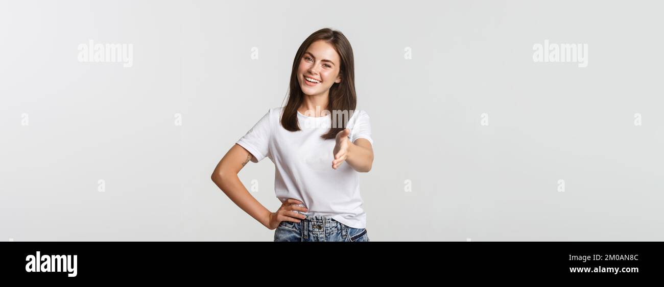 Smiling confident young woman extend hand for handshake, greeting ...