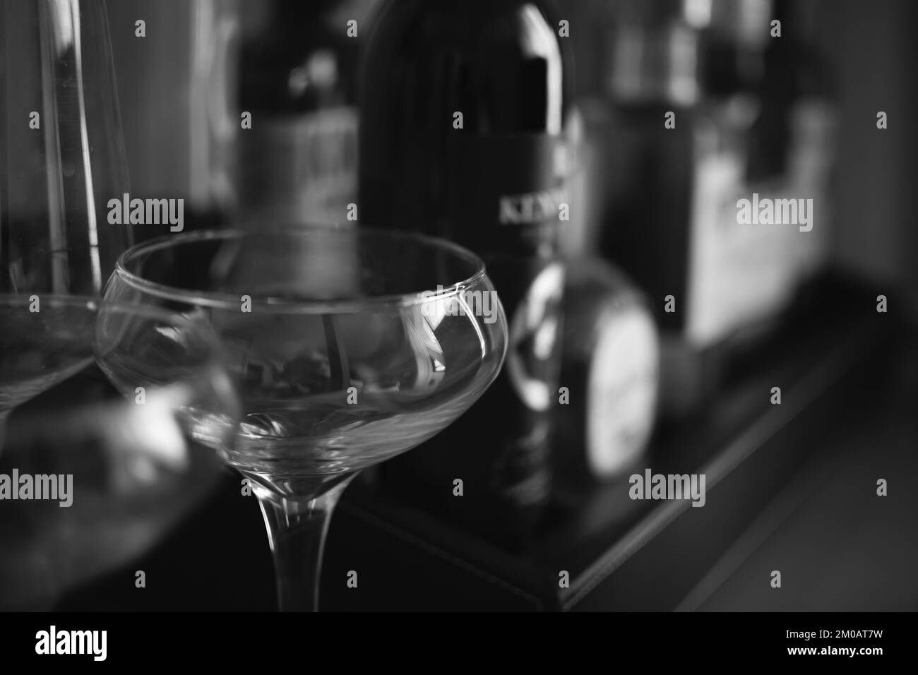 Wine bottle and glass on table Black and White Stock Photos & Images ...