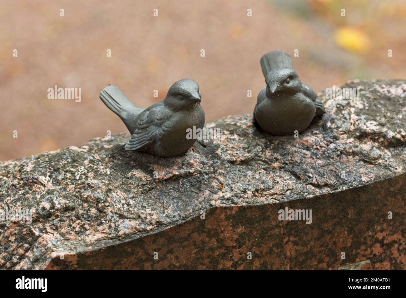 Metal sculpture of two birds in cemetery Stock Photo - Alamy