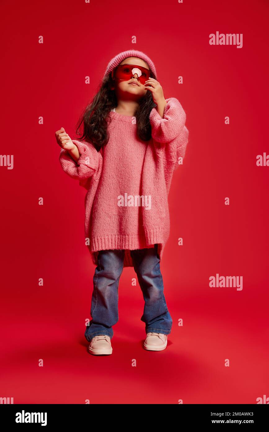 Little girl, child, posing in oversized pink sweater, red glasses and ...