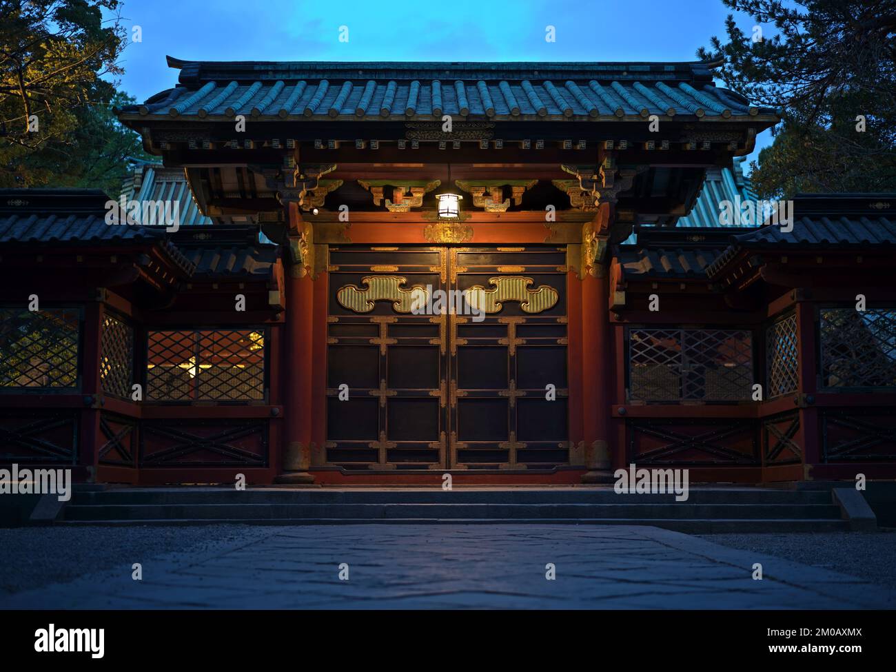 The traditional Karamon gate of the Shinto Nezu shrine illuminated by a ...