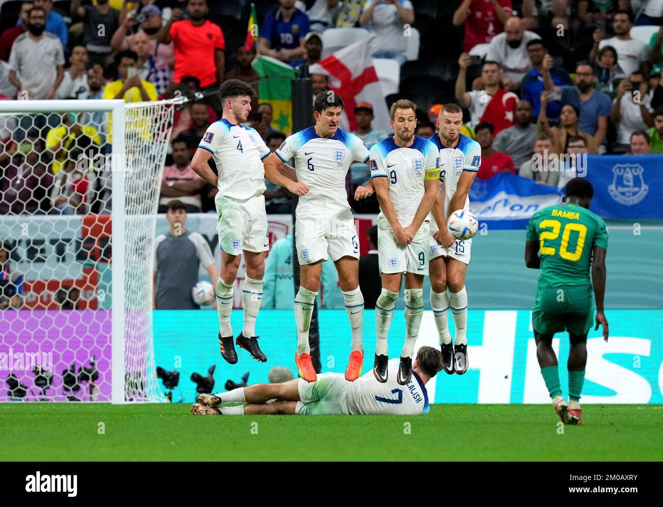 England players defend a free kick from Senegal's Bamba Dieng during ...