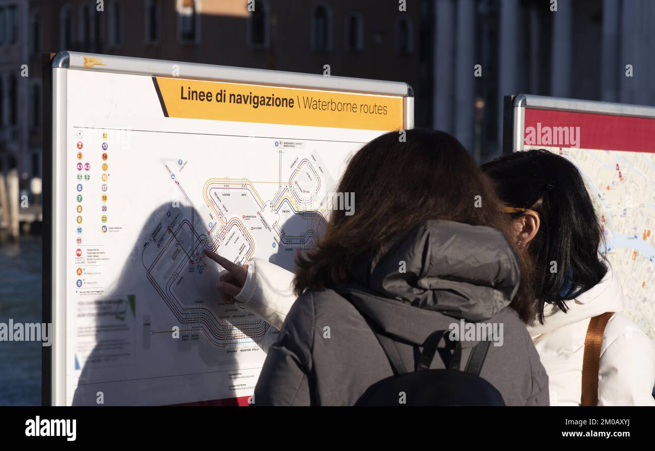 Two female tourists read the navigation map while choosing route ...