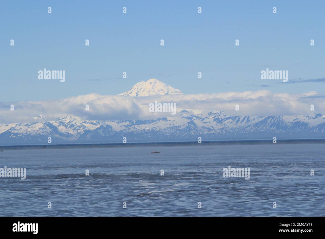 Snowy mountains over the ocean Stock Photo - Alamy