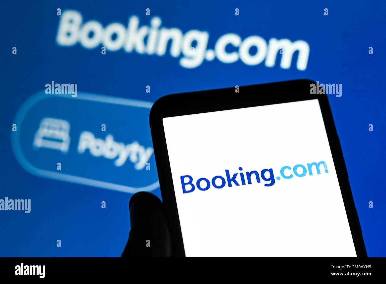 In this photo illustration a Booking.com logo seen displayed on a ...