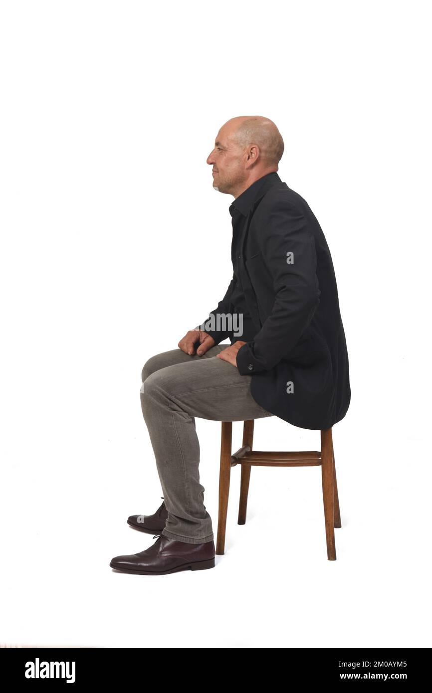 side view of a man sitting on chair with on white background Stock ...
