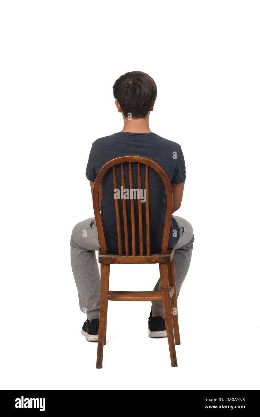 back view of teenage boy sitting on a chair with white background Stock ...