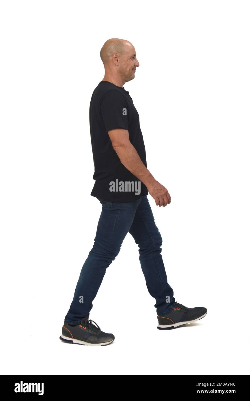 side view of a full portrait of a bald man walking on white background ...