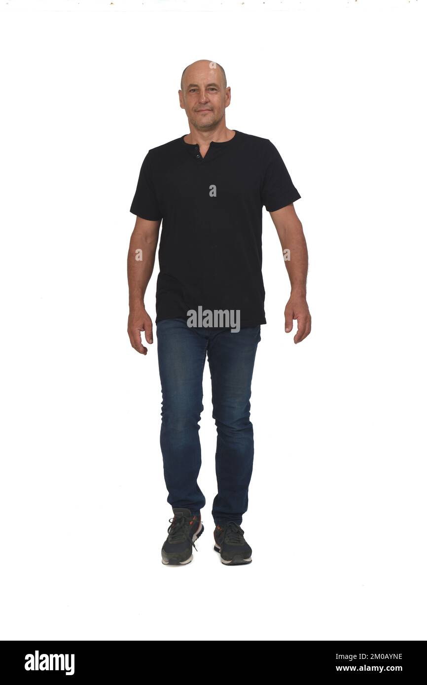 front view of a full portrait of a bald man walking on white background ...