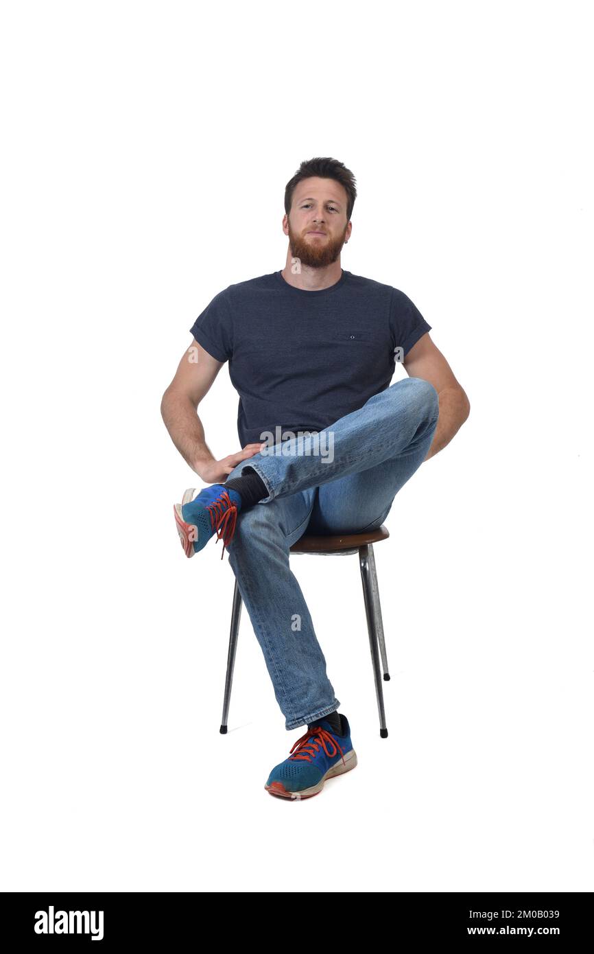 confident man with crossed-legged sitting on chair on white background ...