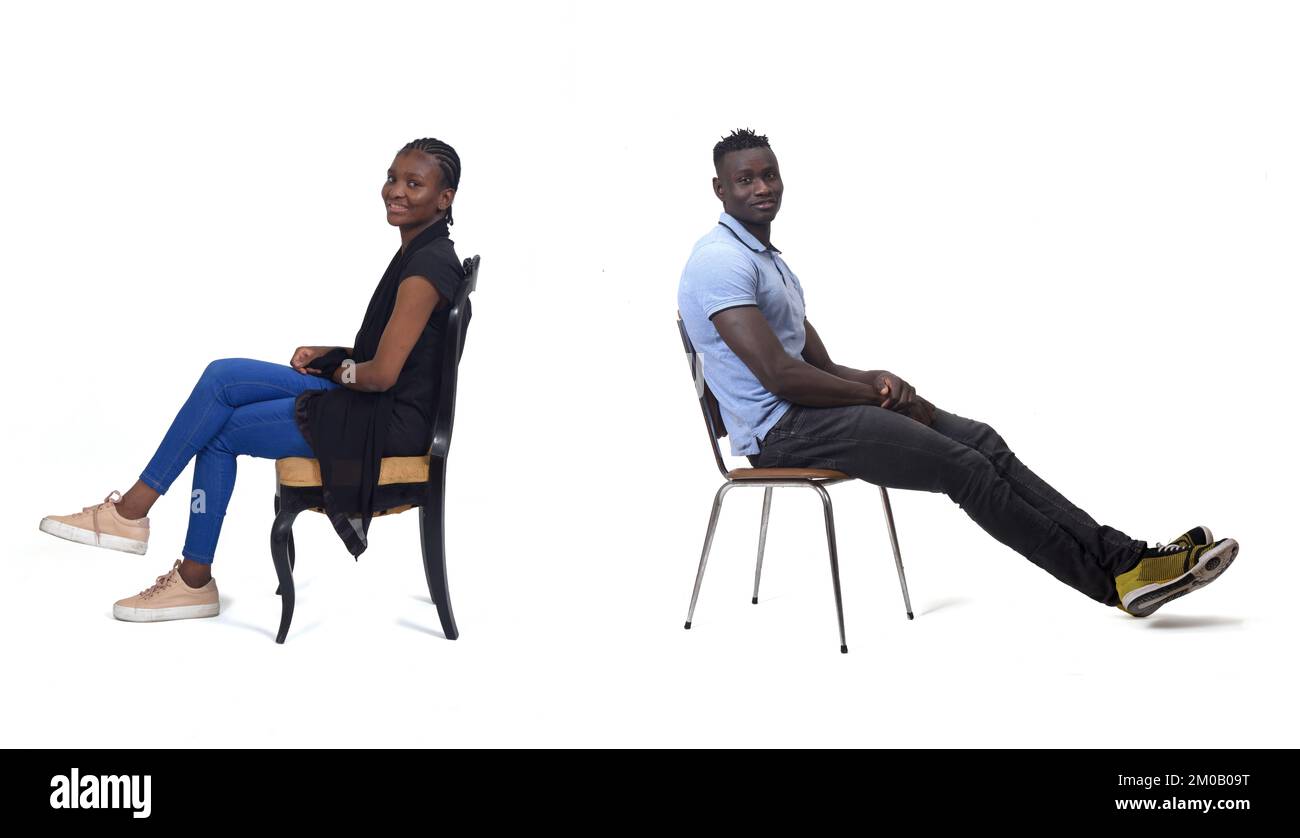 couple sitting on chair over white background Stock Photo - Alamy