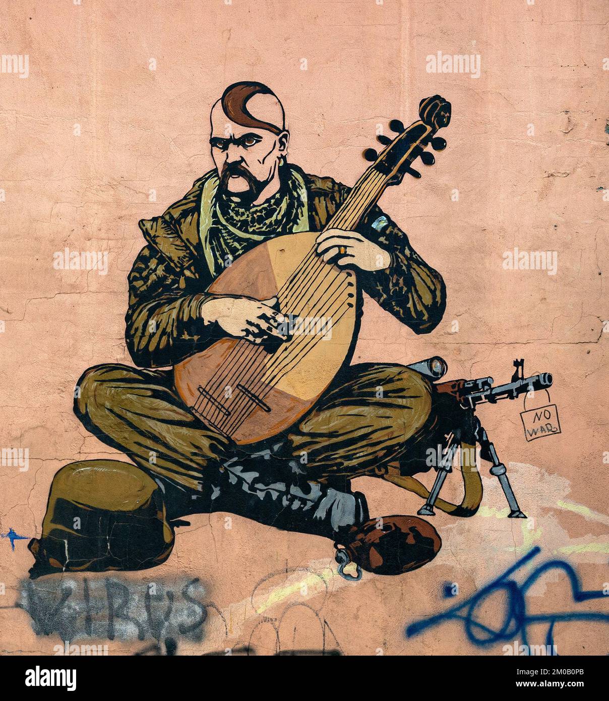 Lviv, Ukraine. Mural of an angry soldier in the field playing his ...