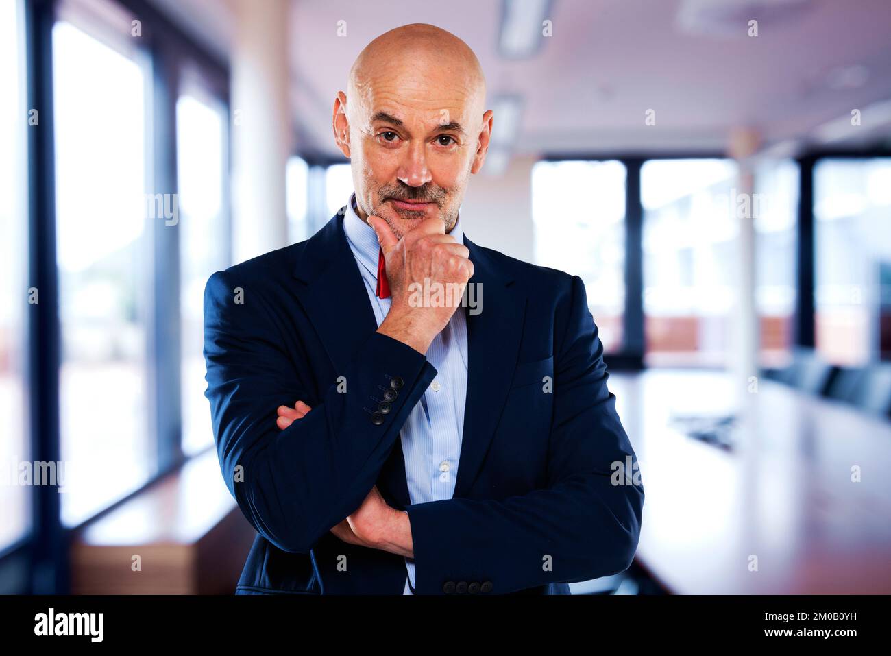 Portrait of confident male CEO standing at the office. Mature manager ...