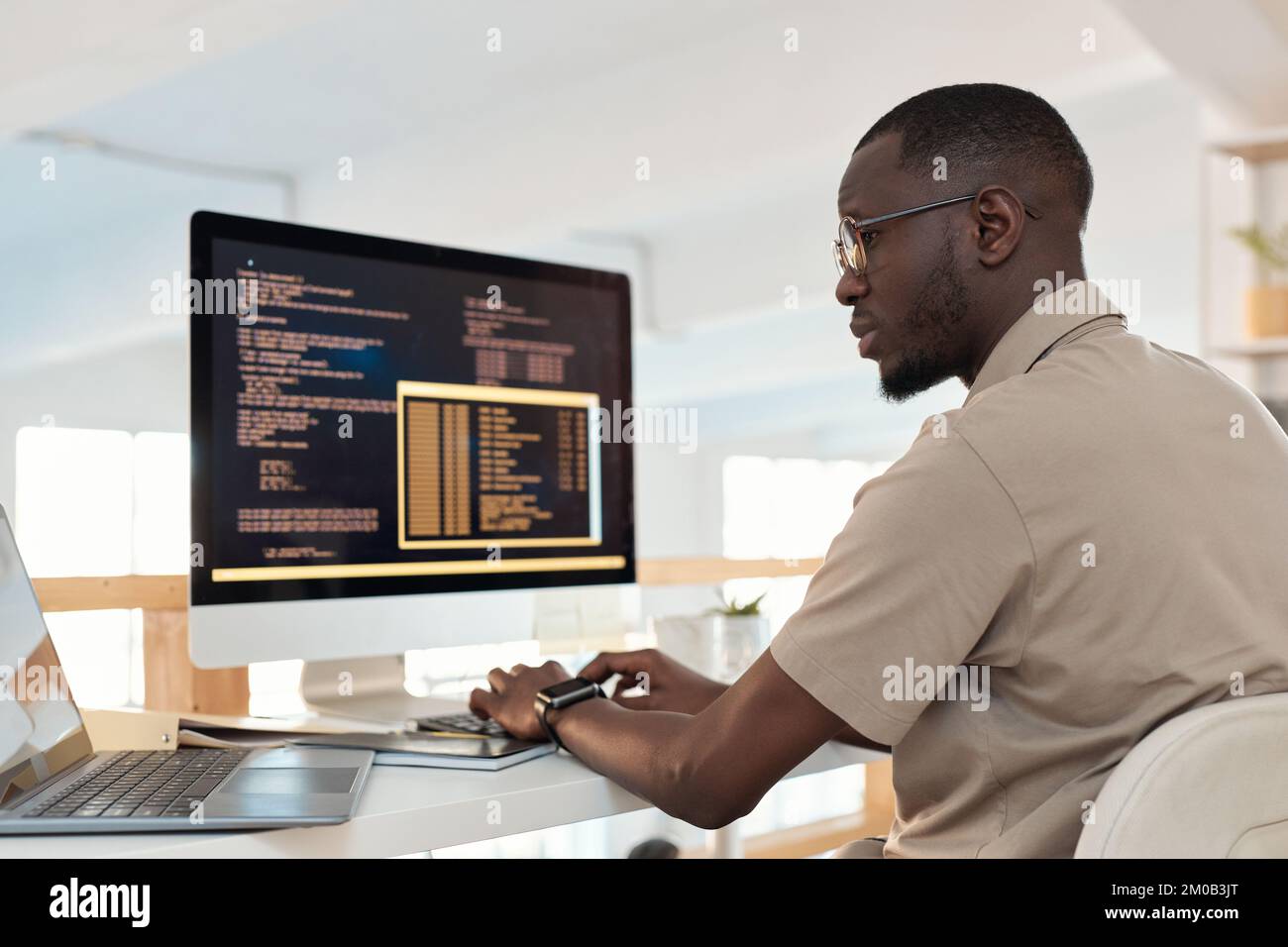 Serious programmer working on ways to automate and release processes ...