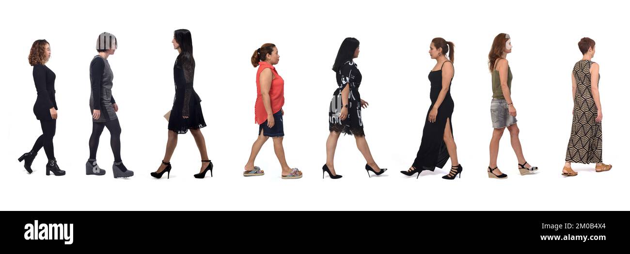 side view of a group of women walking with dress and skirt on white ...