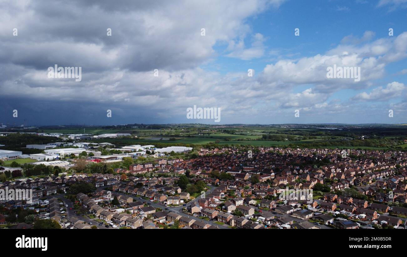 A beautiful view of a town with small houses under the blue cloudy sky ...