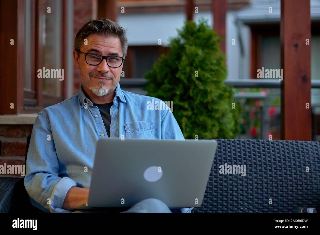 Outdoor portrait of mid adult man in 50s, happy confident smile ...