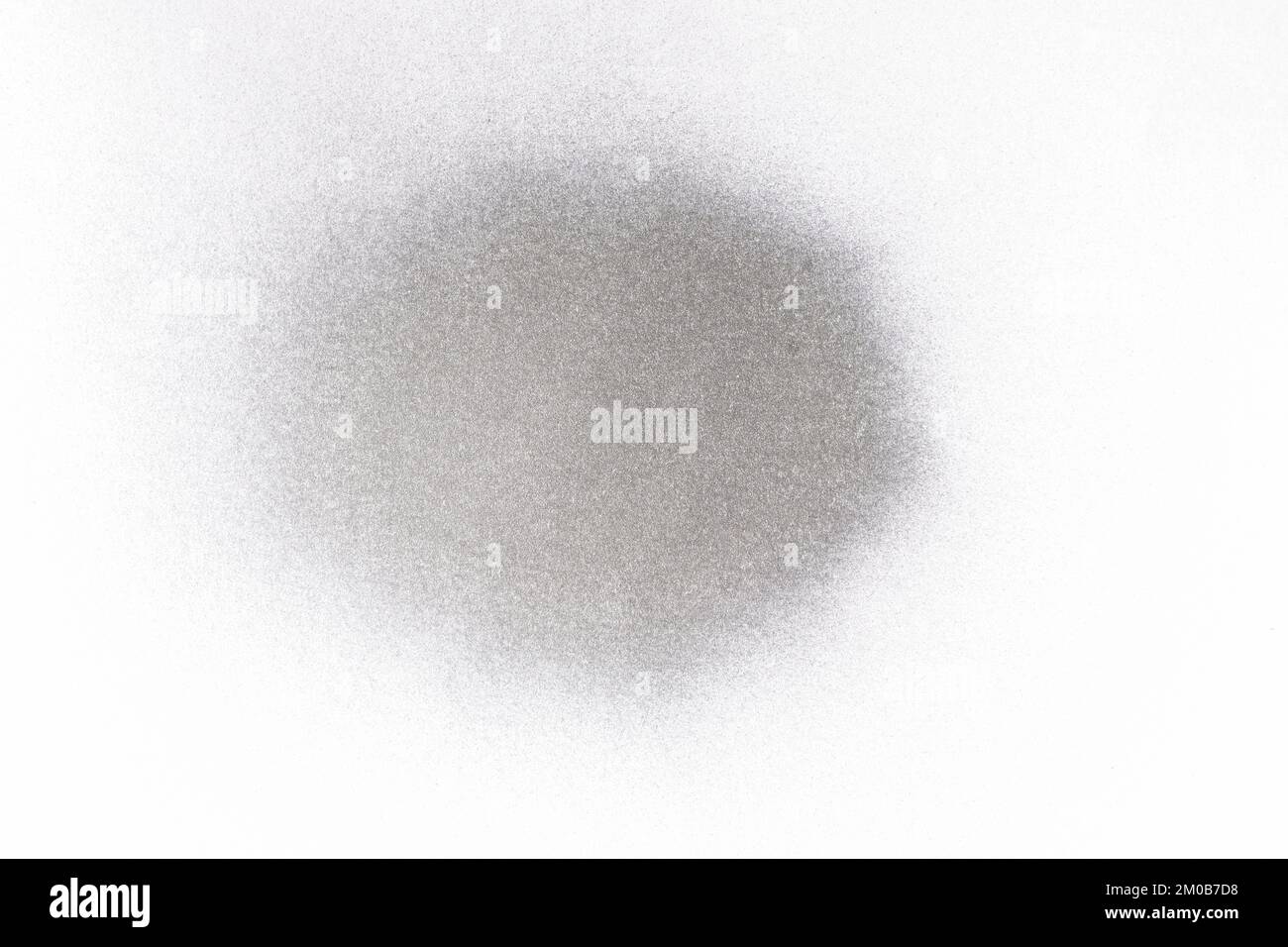 a spray spray paint stain on a white paper background Stock Photo - Alamy