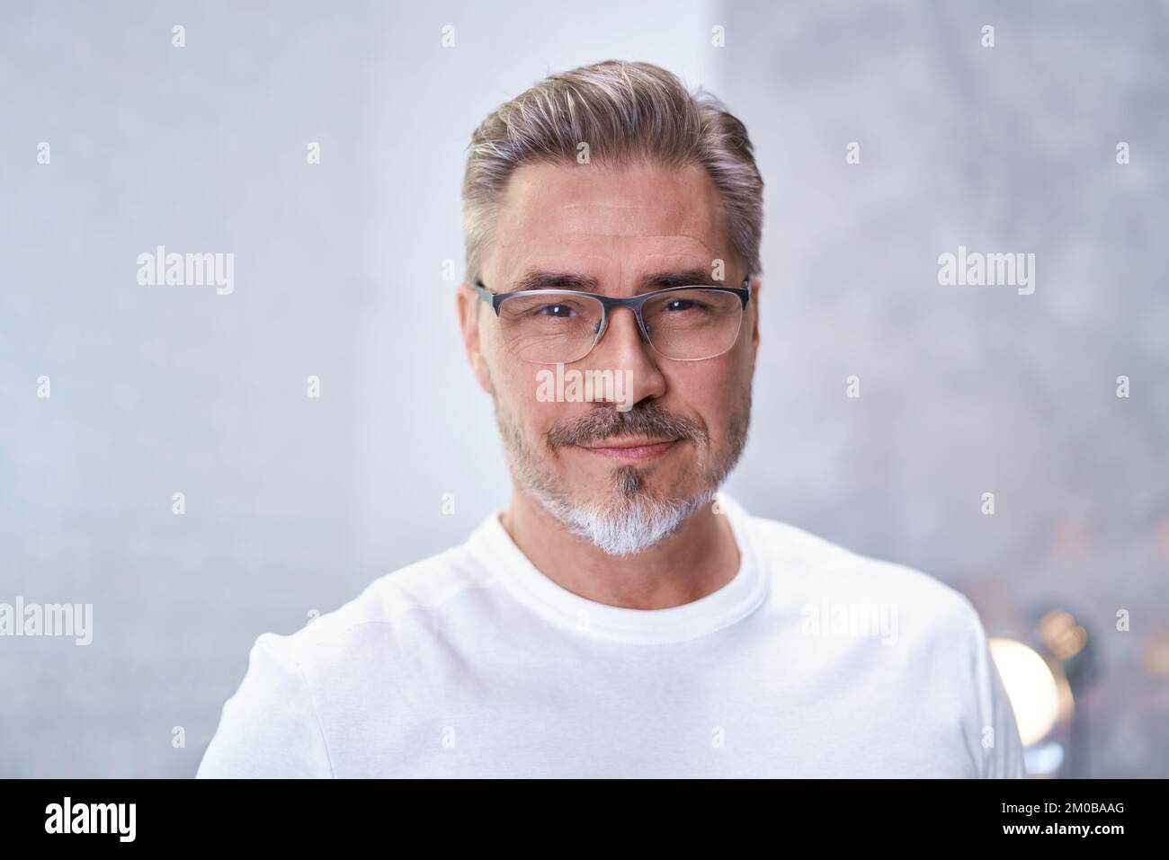 Portrait of mature age, middle age, mid adult casual man at home in ...