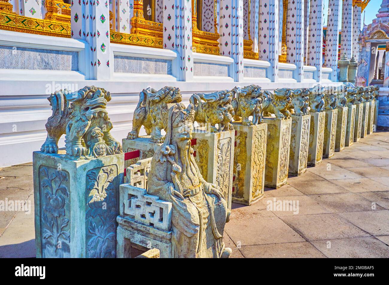 The line of stone Singhas and sitting Chinese old Sage in the courtyard ...