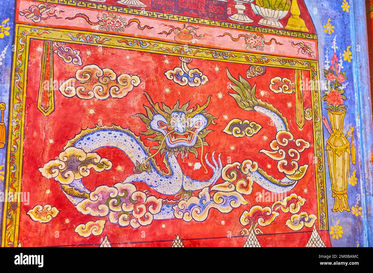 Colorful fresco of the mythologial Naga serpent creature on the wall of ...