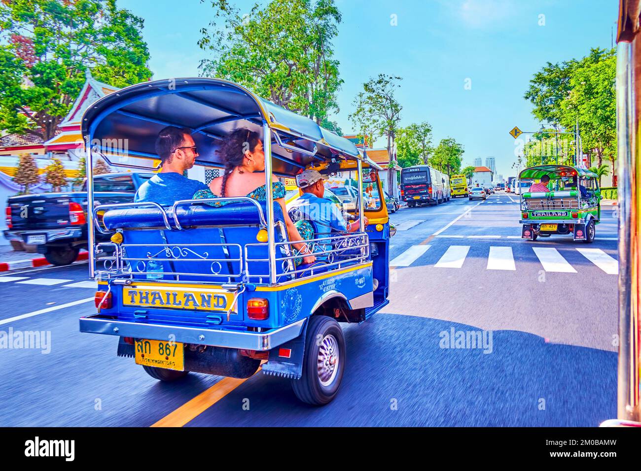 BANGKOK, THAILAND - APRIL 23, 2019: Fast tuk-tuk taxi riding along wide ...