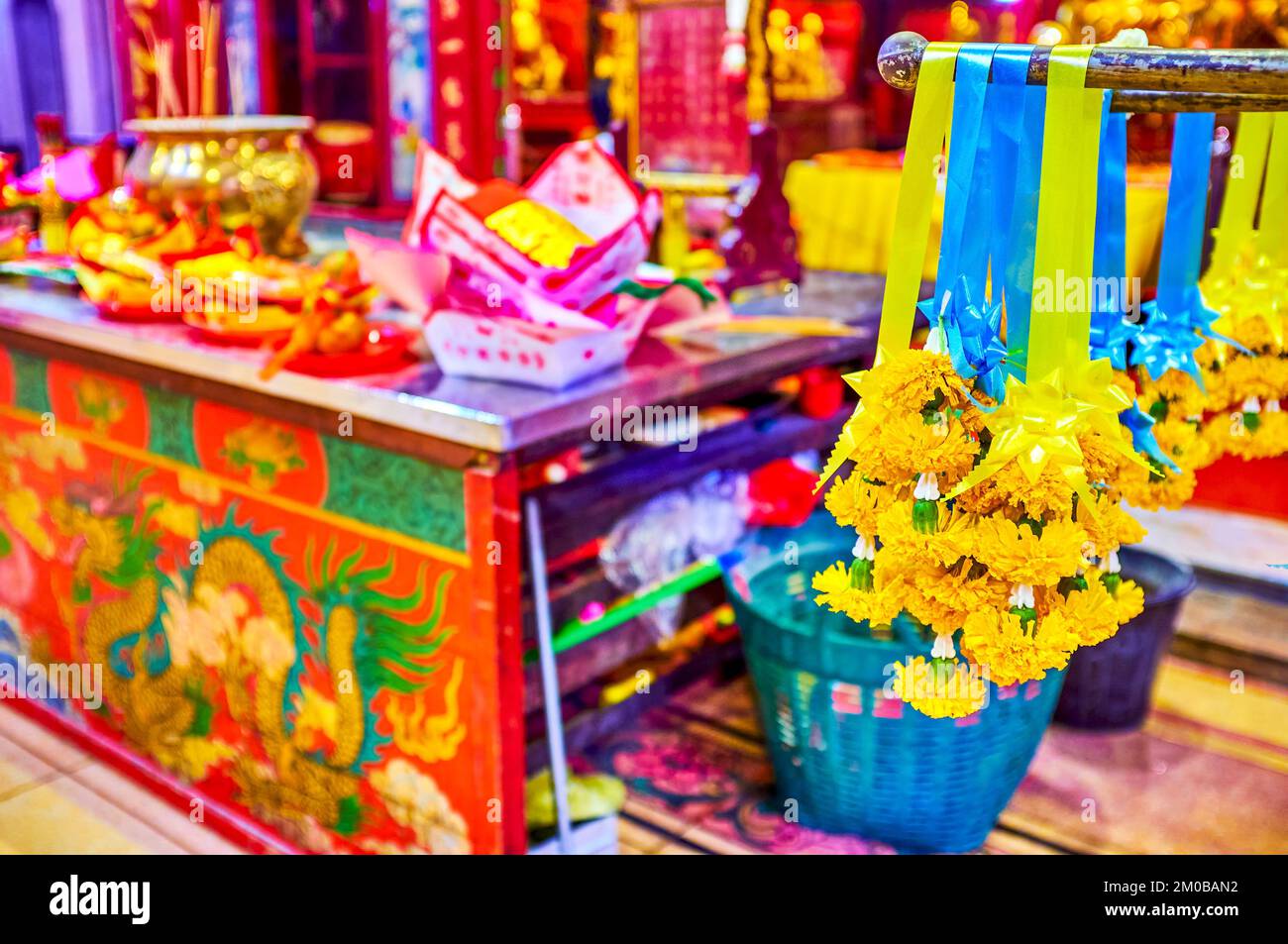 The fresh marigold flowers with blue and yellow stripes at the Altar of ...