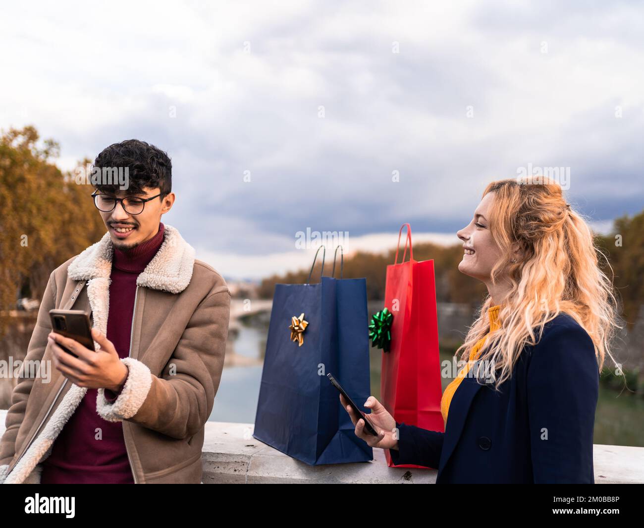 selective focus arab man chatting at smartphone after shopping with his ...