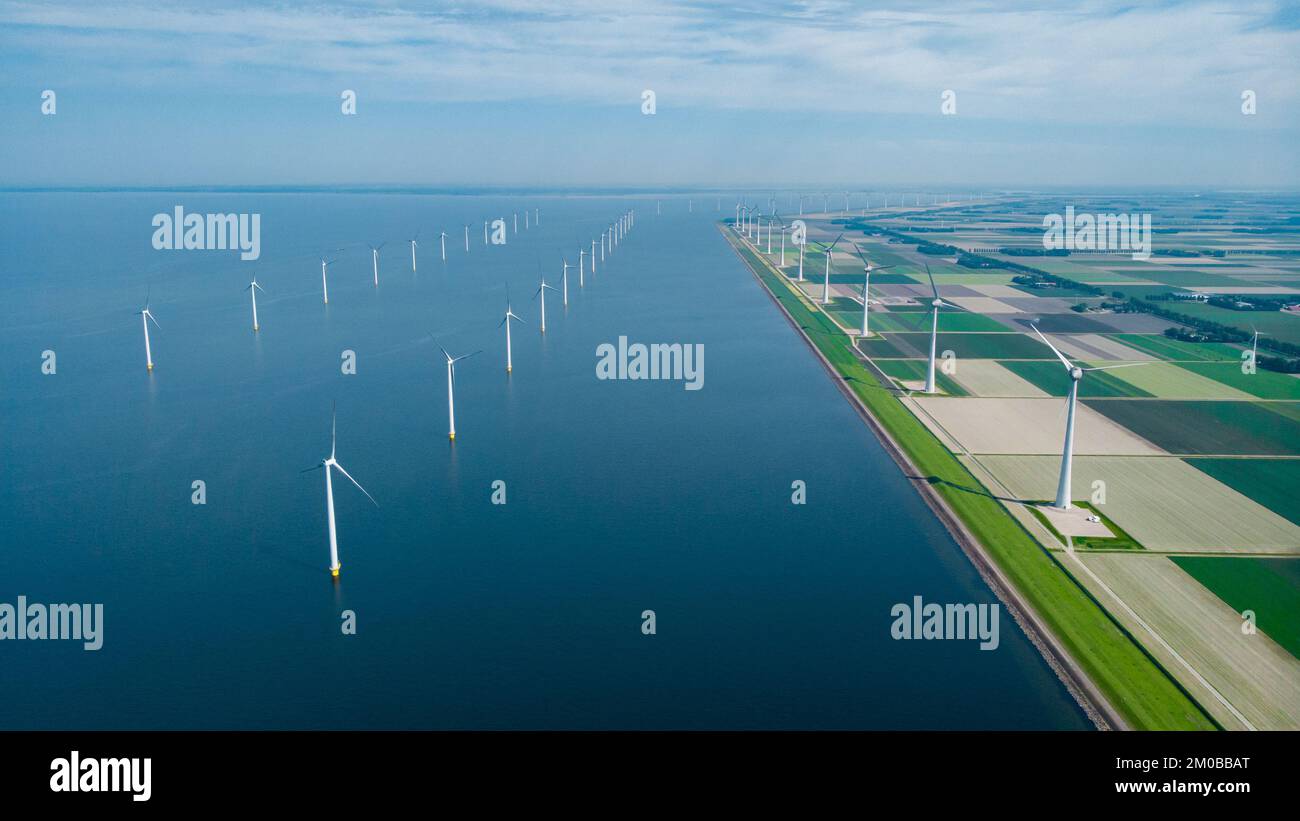 Windmill turbines at sea view from a drone aerial view from above at a ...