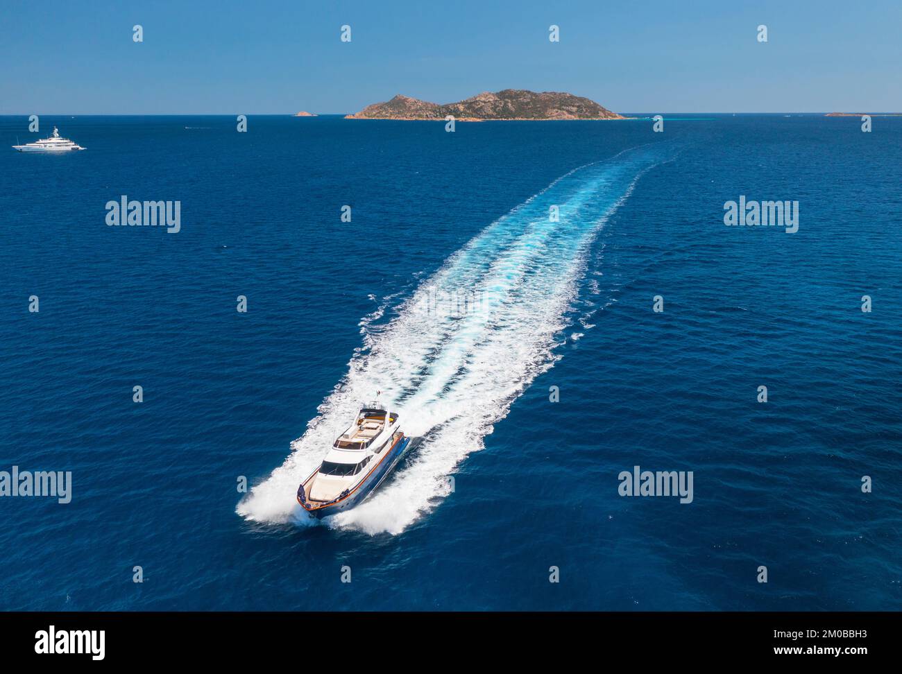 Aerial view of beautiful floating luxury yacht in blue sea at sunset in ...