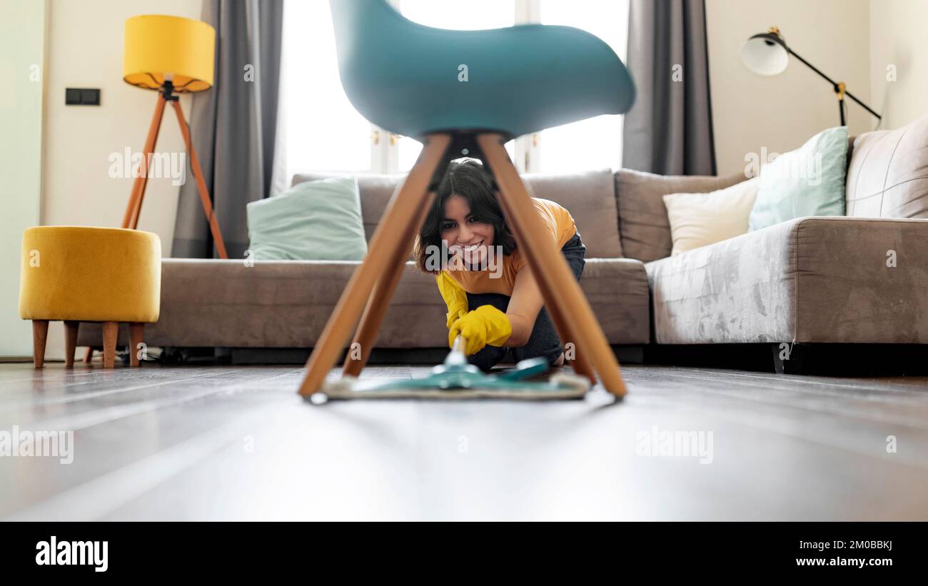 Woman clean dust under chair hi-res stock photography and images - Alamy