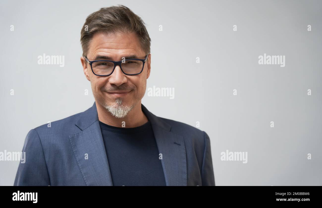 Confident businessman in glasses smiling. Portrait of mature age ...
