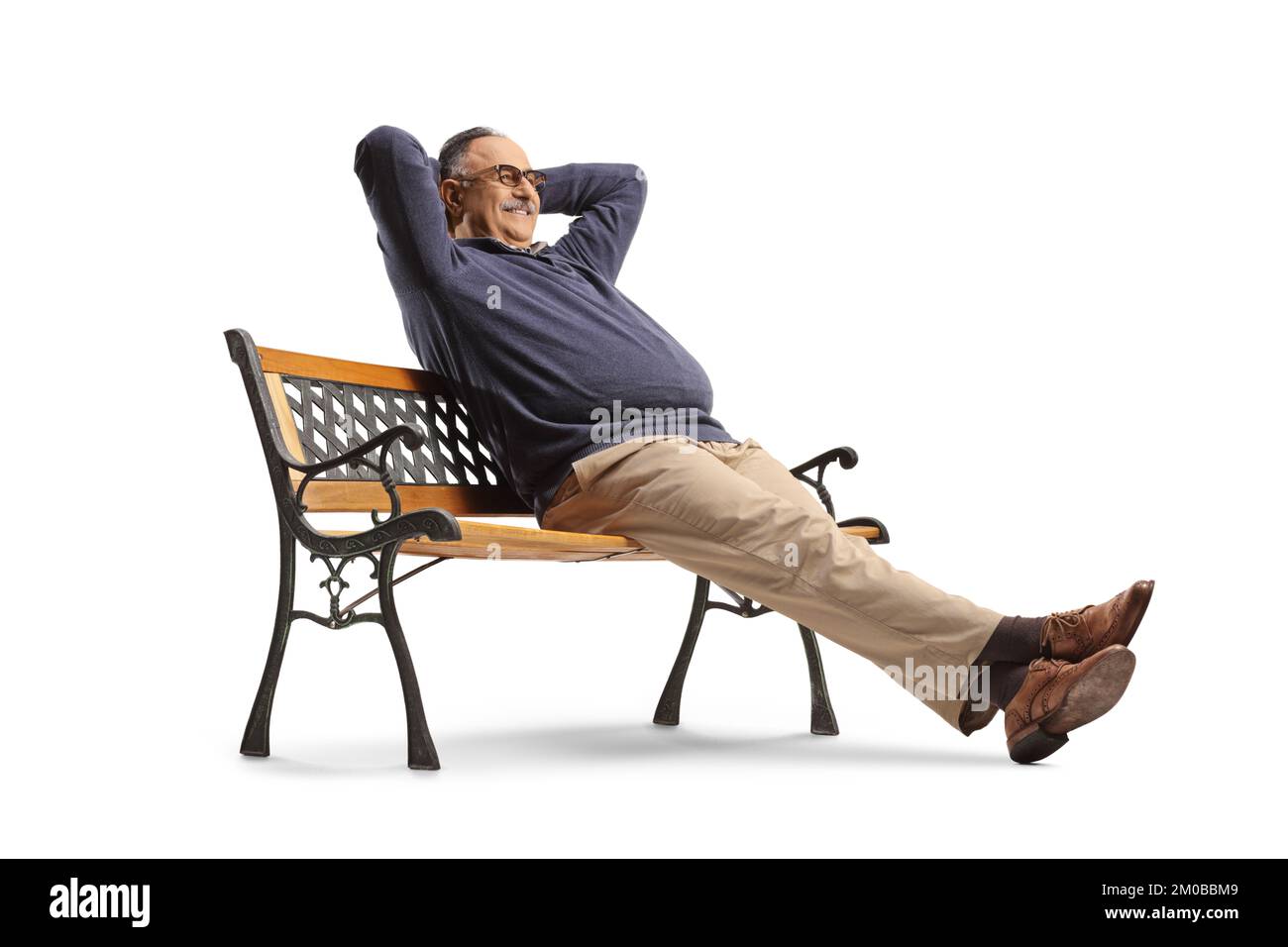 Careless mature man sitting on a bench and resting isolated on white ...