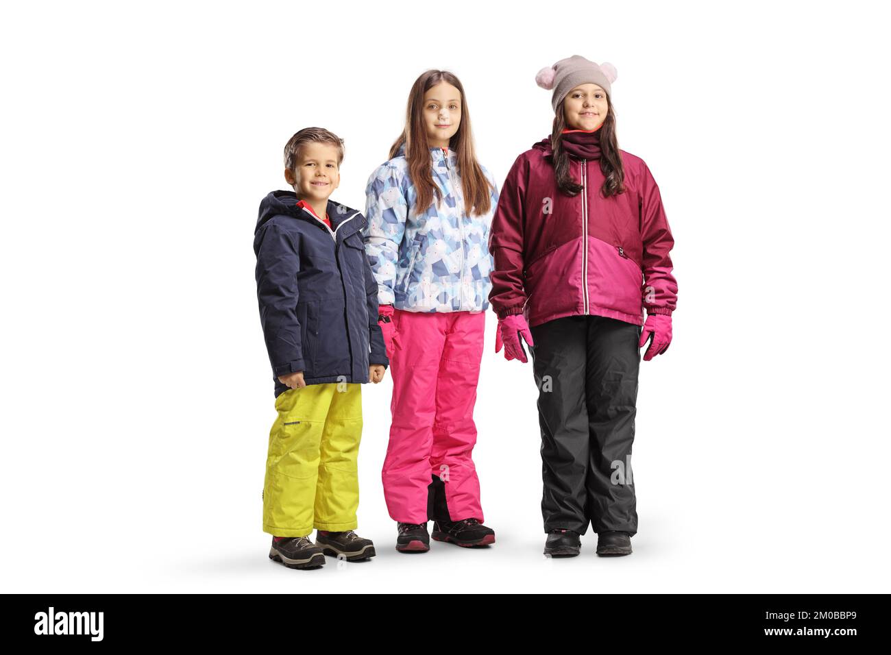 Two girls and a boy wearing winter clothing isolated on white ...