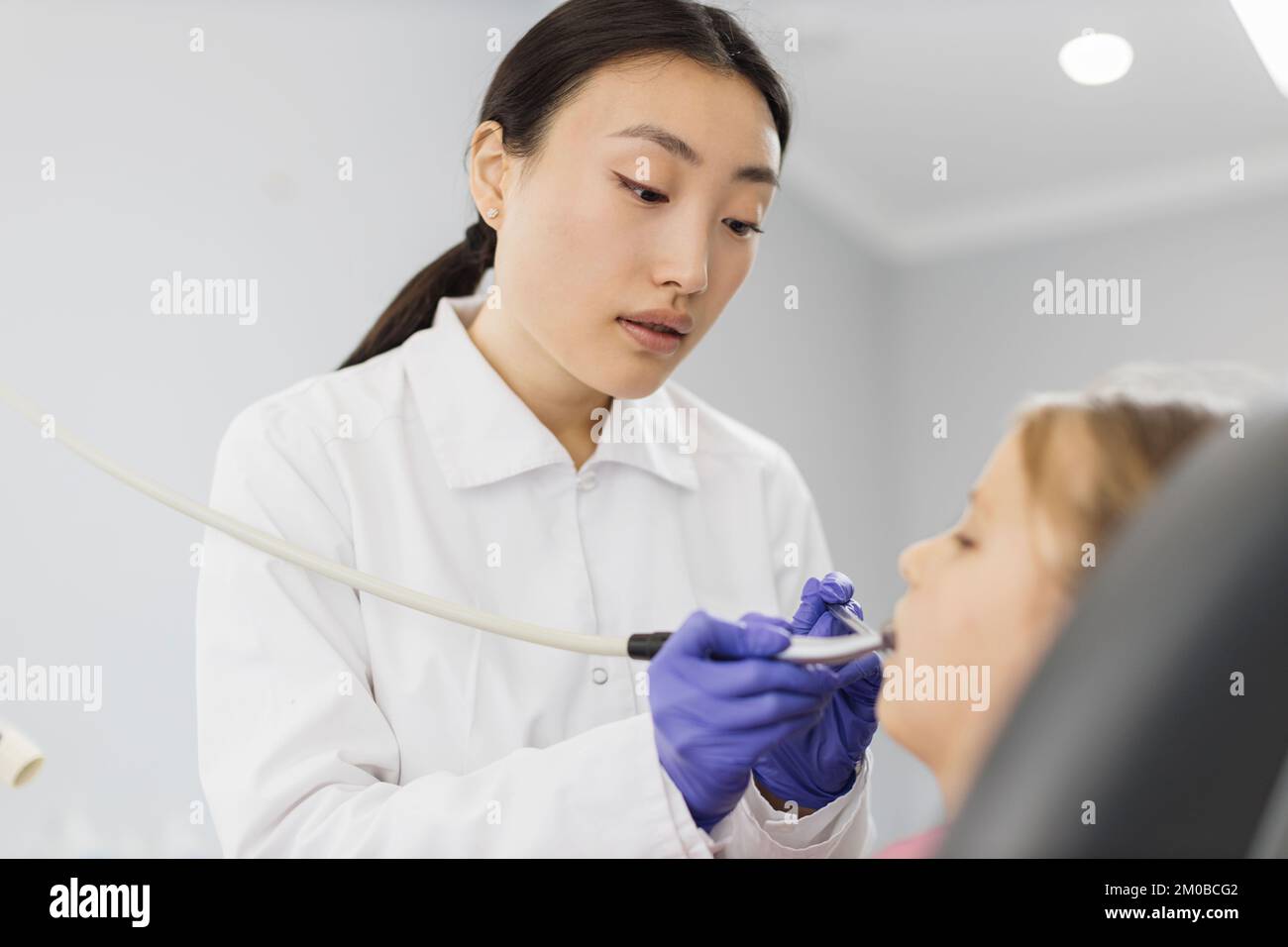 Cute pretty little girl during the dental procedure at the modern ...