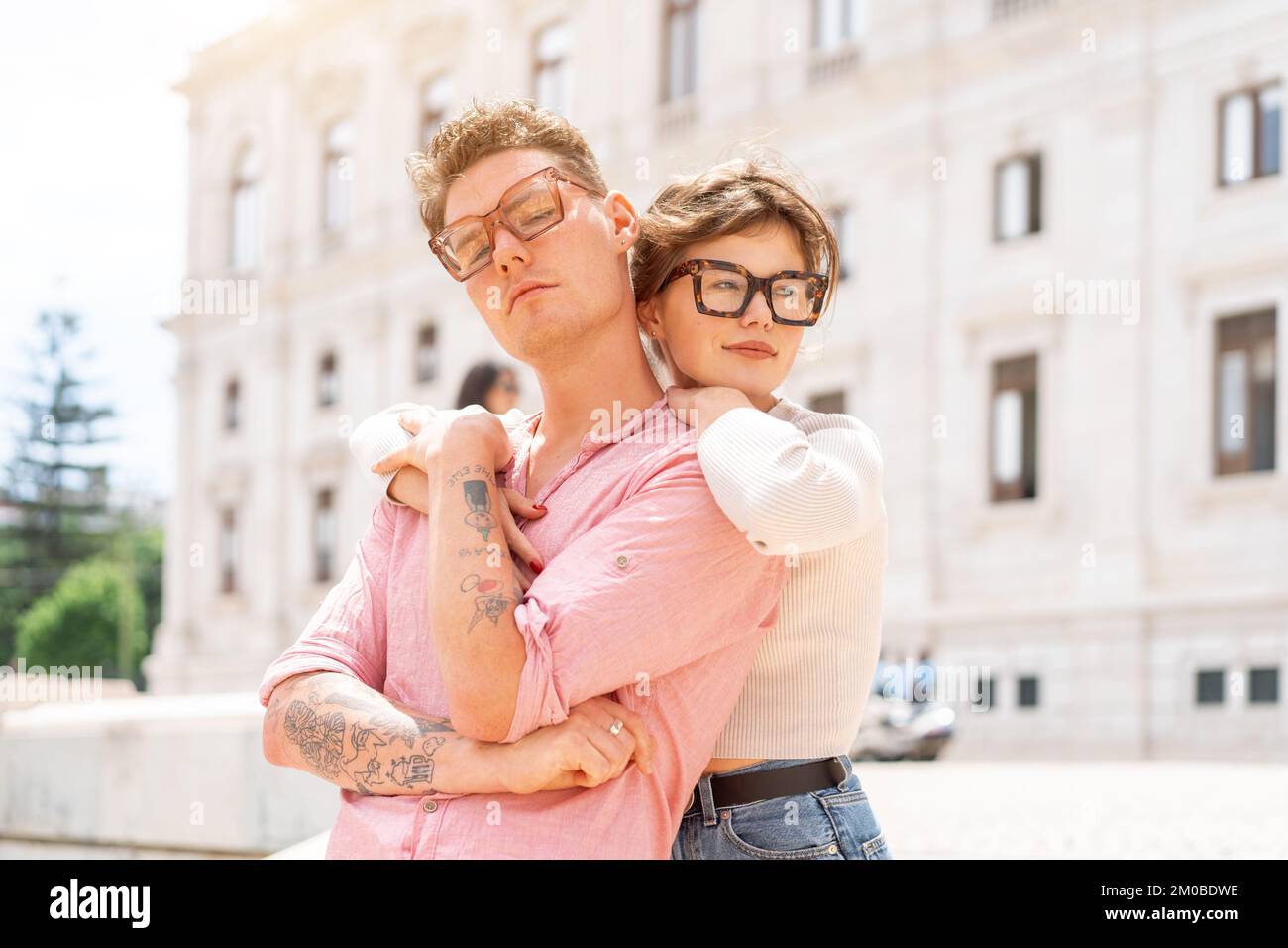 Young beautiful hipster couple in love walking on old city street ...