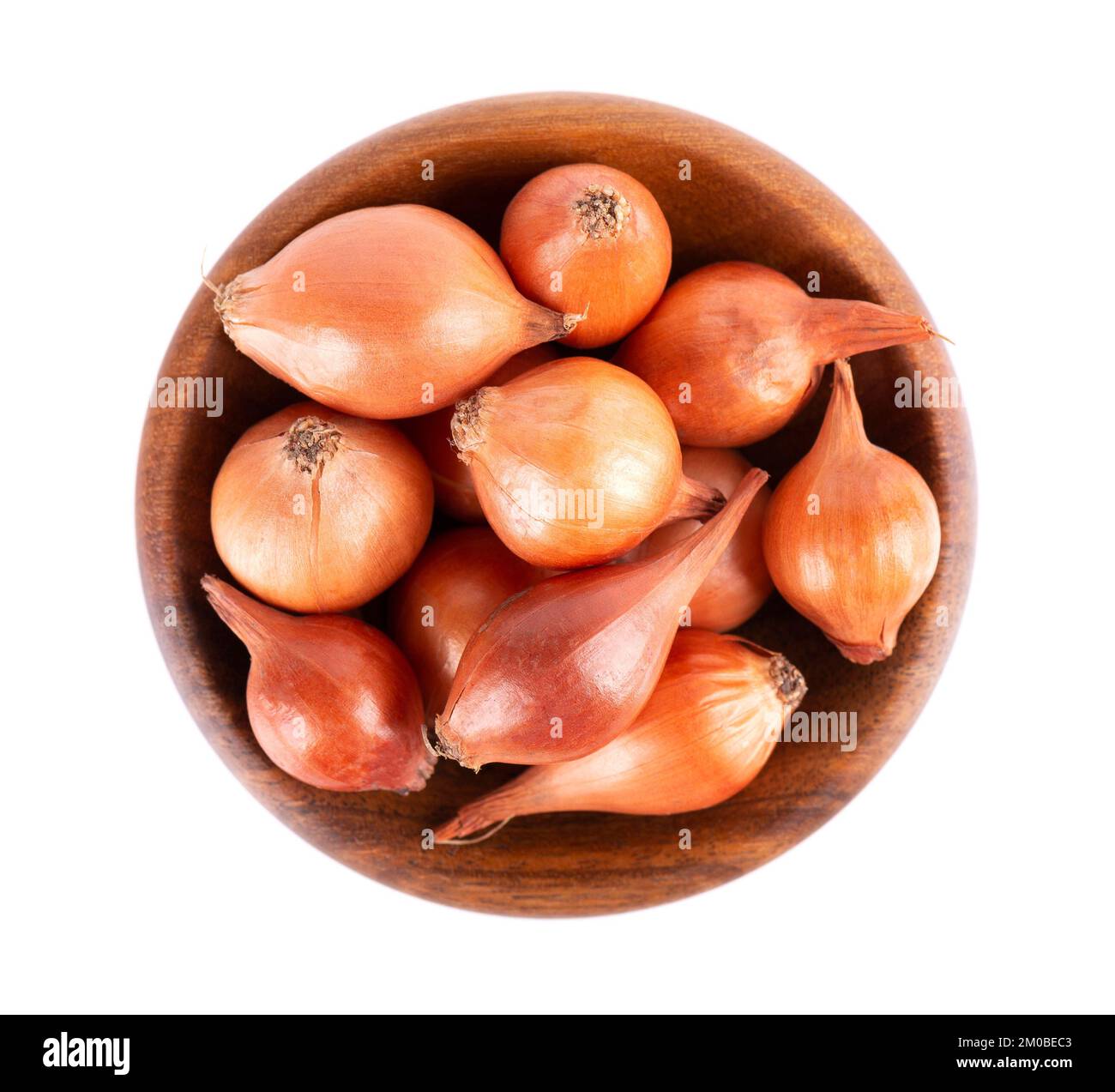Brown mini onions in wooden bowl, isolated on a white background. Raw ...
