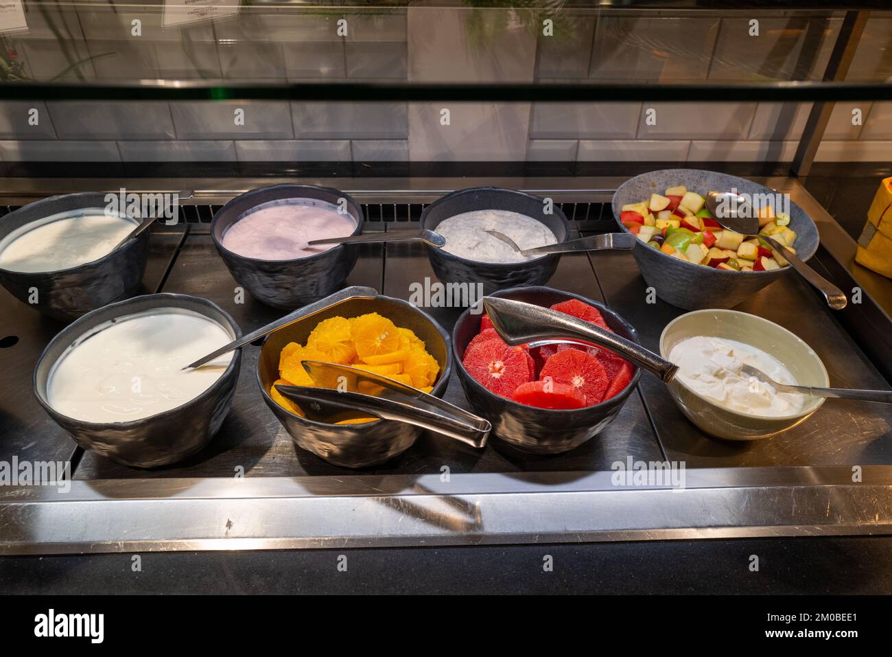 on the breakfast buffet there are different kinds of yogurt and fruit ...