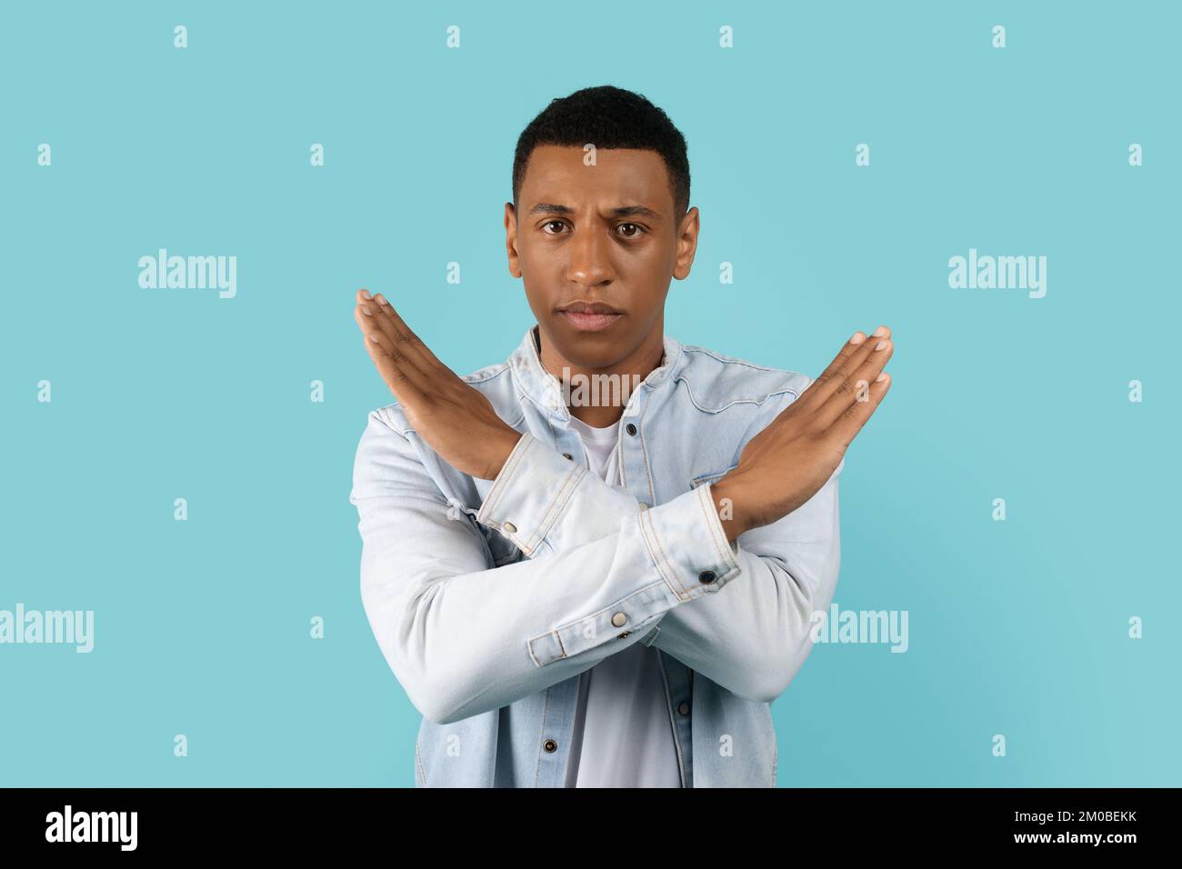 Sad serious handsome young african american man in casual crossed arms ...